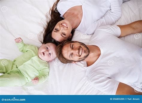 He Always Wants To Be Close To Mommy And Daddy A Young Couple Lying On