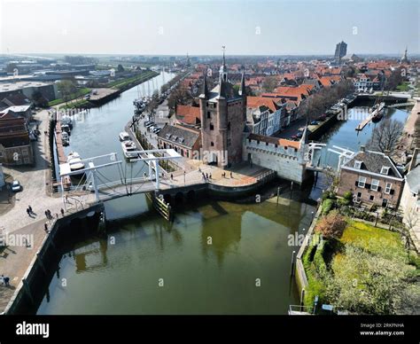 An Aerial View Of An Urban Cityscape Features A Canal With Multiple