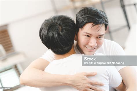 Happy Asian Gay Couple Hug Together On Sofa Asian Lgbt Couple Embracing