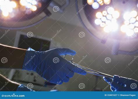 Close Up Of Gloved Hands Passing The Surgical Scissors Operating Room