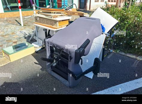 Assorted Discarded Items Including Overturned Office Chair Wooden