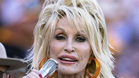 Dolly Parton 77 Flashes Her Famous Cleavage In A Bedazzled White
