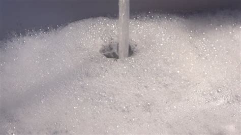 Foam And Soap Bubbles From Water In A Sink With Water Running From A