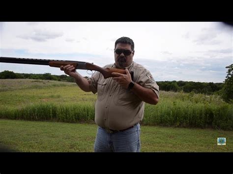 A Person Shooting A Shotgun