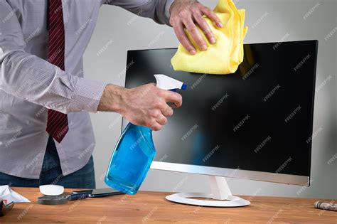 Premium Photo Clean The Computer Screen With A Rag