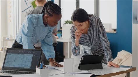 Free Photo Close Up Of Multi Ethnic Women Working Together To Design Construction Blueprints