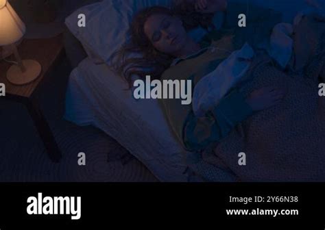 Young Female Napping At Home In Darkness Woman Sleeping In Bed In Dark