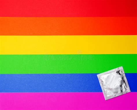 Condom On Lgbt Rainbow Flag Background Protected And Safe Sex Concept
