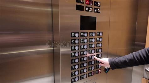 Woman Tapping And Pressing The Ten Button Inside The Elevator Stock