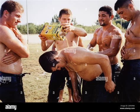 Group Of Men Engaging In Traditional Turkish Oil Wrestling Training