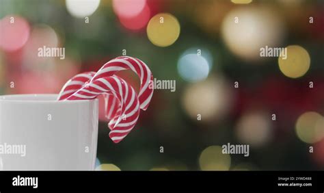 Candy Canes Rest In A Mug Against A Festive Backdrop With Copy Space