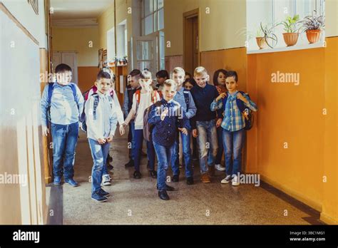 Happy Pupils Running Out Of The Classroom On Summer Vacation Stock