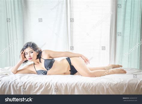 Стоковая фотография 322453157 Sexy Asian Woman Black Bikini Lying