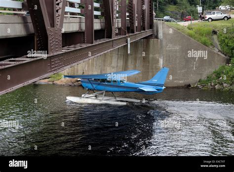 Cessna Float Plane Seaplane Taxing Under A Bridge At Long Lake New York