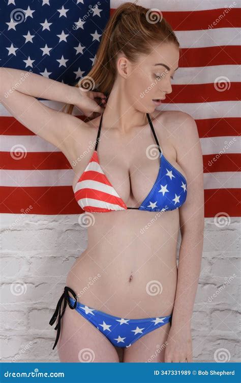 Tall Attractive Redhead Model In A Stars And Stripes Bikini Stock