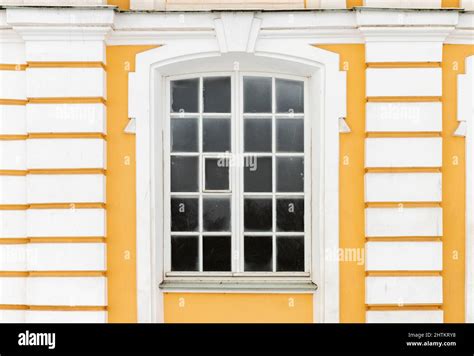 Classical Window With White Frame In Yellow Stone Wall Background