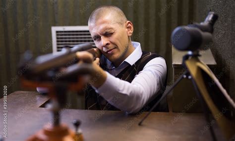 Concentrated Man Zeroing Semi Automatic Hunting Rifle From Bench Rest