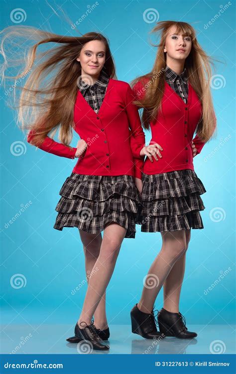 Dos Colegialas Adolescentes Se Colocan De Lado A Lado Sobre Fondo Azul