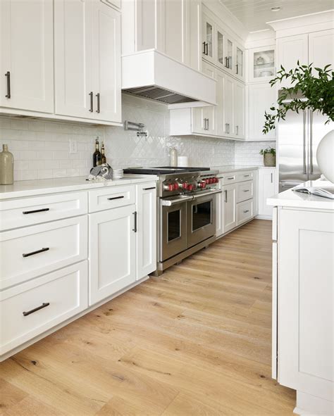 White Kitchen Cabinets Paired With Light Hardwood Floors White Oak