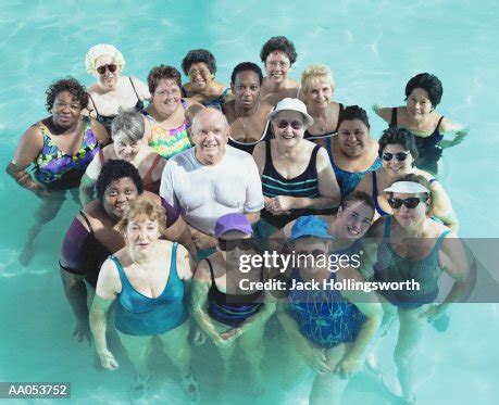 Group Of People Standing In Pool Preparing For Water Aerobics Class