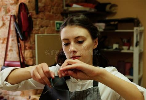 A Young Woman Makes Details For A Leather Bag In Her Workshop Hobby
