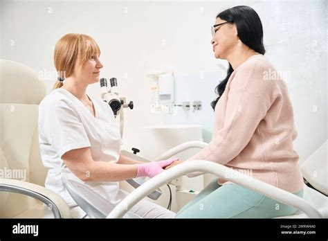 Woman Gynecologist Talking To Patient After Examination On Medical