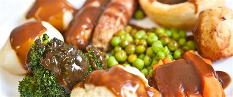 Pork Sausage Served With Yorkshire Pudding Roast And Boiled Potatoes