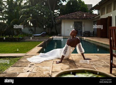 Ambiguous Gender Fluid Black Person In Elegant White Dress Villa