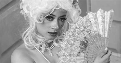 Woman In Rococo Costume Standing By Railing And Holding Hand Fan · Free