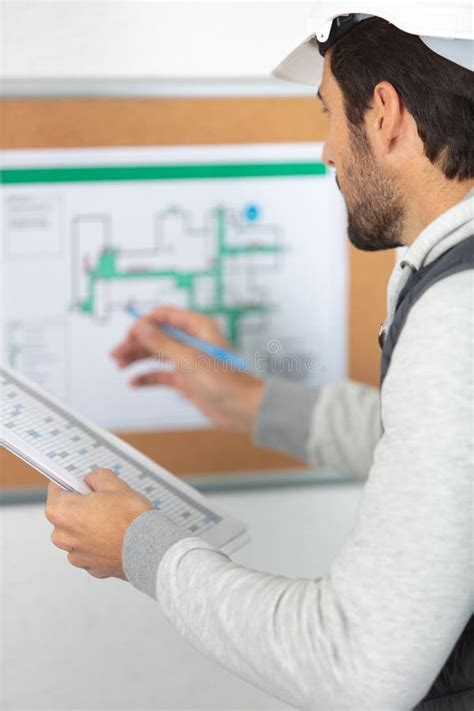 Architect Checking Insulation During House Construction Stock Image