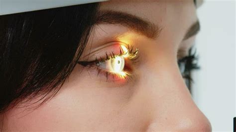 Eye Iris And Pupil Macro Reflected Moving Light Rays Into The Human