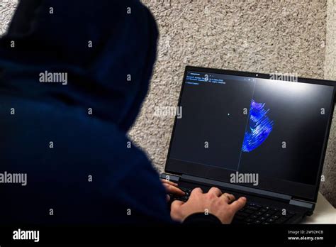 Man Looked Like Hacker In A Hood Sitting In The Front Of Laptop