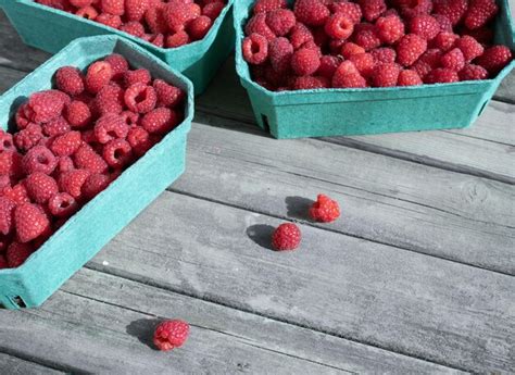 Premium Photo Ripe Raspberry In Tray On Wooden Table