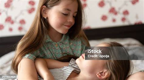 Happy Time Concept Sisters Lying In Bed And Smiling Girls Playing