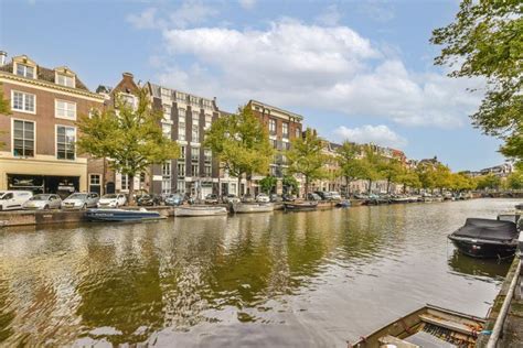 A Canal With Boats And Houses On The Water Editorial Photo Image Of
