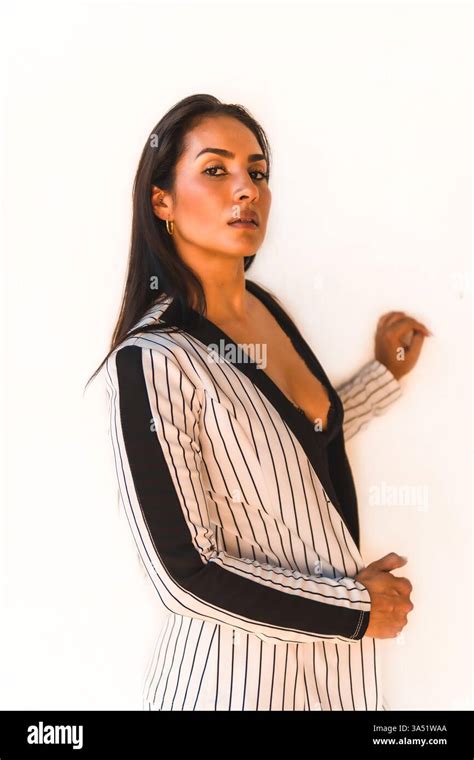Lifestyle Straight Haired Latin Brunette Girl In A White Suit And