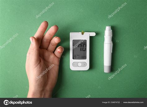 Woman Measuring Glucose Level Digital Glucometer Color Background