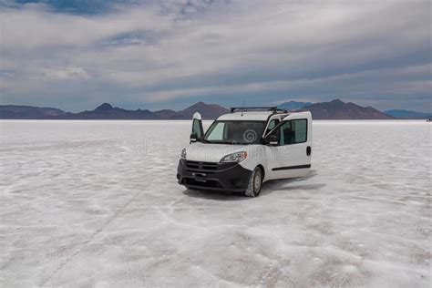 A 4x4 Camping Van Driving On Bonneville Salt Flats In Western Utah With