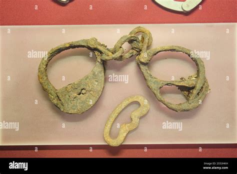 A Display Of Old Rusty Green Patina Handcuffs Clamps At The