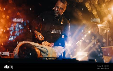 Two Police Officers Arrest Suspect Put Him On A Patrol Car Hood Officers Of The Law Handcuff