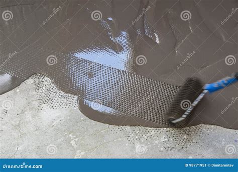 Spreading Self Leveling Plaster With A Special Roller Interior Stock Image Image Of Indoors