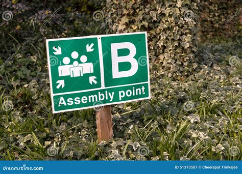 Fire Assembly Point Sign At Workplace Car Park Fence Wall Royalty Free
