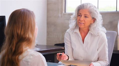 Mature Businesswoman Behind Desk Meeting With Female Interview Candidate Stock Image Image Of