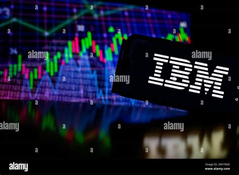 In This Photo Illustration Logo Of Ibm Is Seen On A Smartphone Against A Screen Displaying A