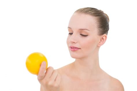 Premium Photo Pensive Pretty Blonde Model Looking At An Orange