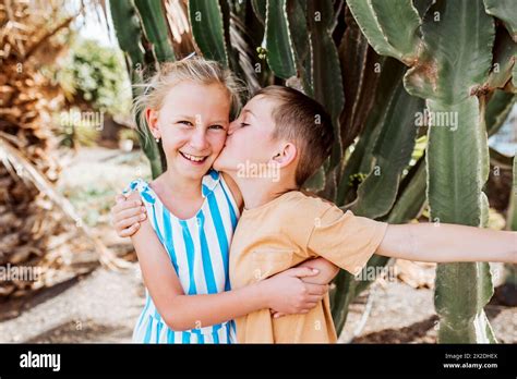 Portrait Of Siblings On Summer Vacation In Holiday Destination Happy Brother Kissing Babe On