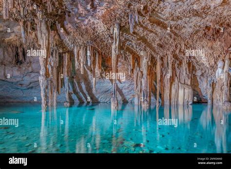 Stalactites And Water Inside Of Cenote Papakal Merida Yucatan Mexico