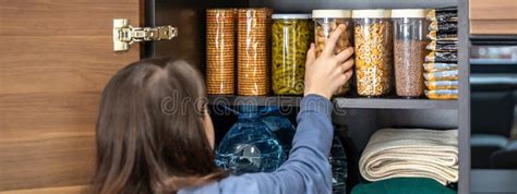 Banner Of Girl Storing Nuts Container In Pantry With Food And Water For