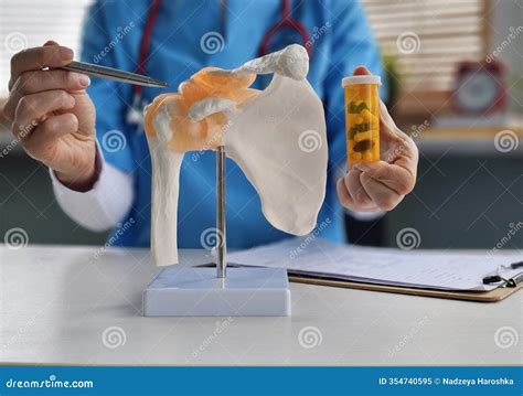 Doctor Discussing Shoulder Anatomy And Medications With A Patient Stock