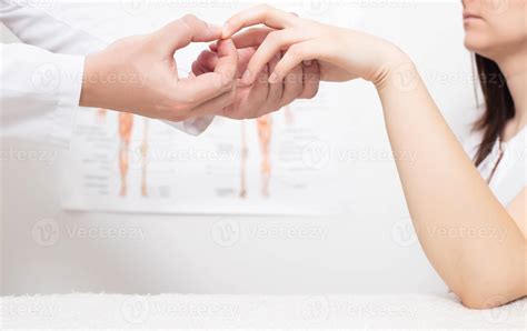 A Neurologist Doctor Checks The Pathological Reflex Of A Hoffman In A